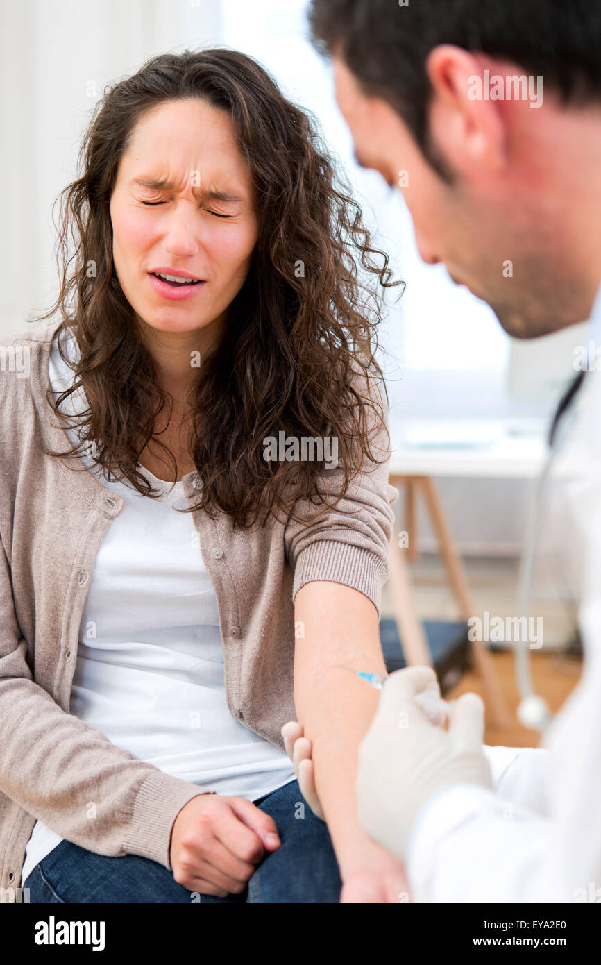 View of an Attractive young woman scared by injection Stock Photo - Alamy