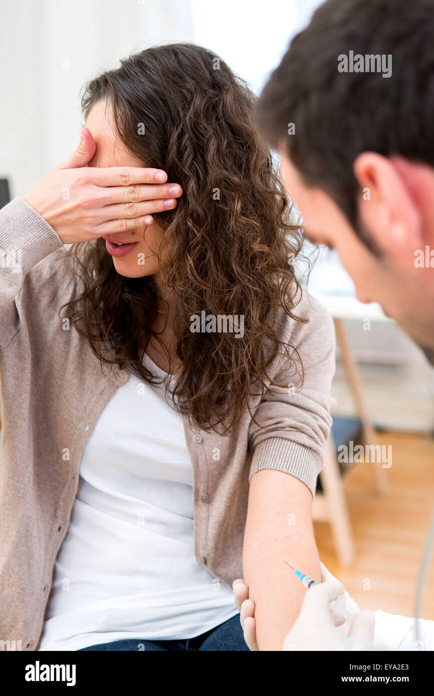 View of an Attractive young woman scared by injection Stock Photo - Alamy