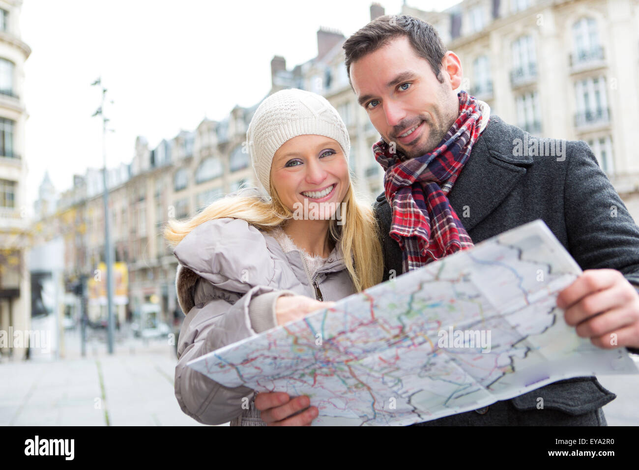 View of a young attractive tourist watching map Stock Photo - Alamy