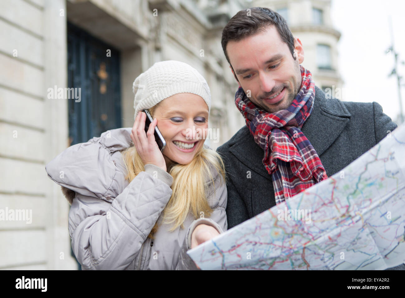 View of a young attractive tourist watching map Stock Photo - Alamy