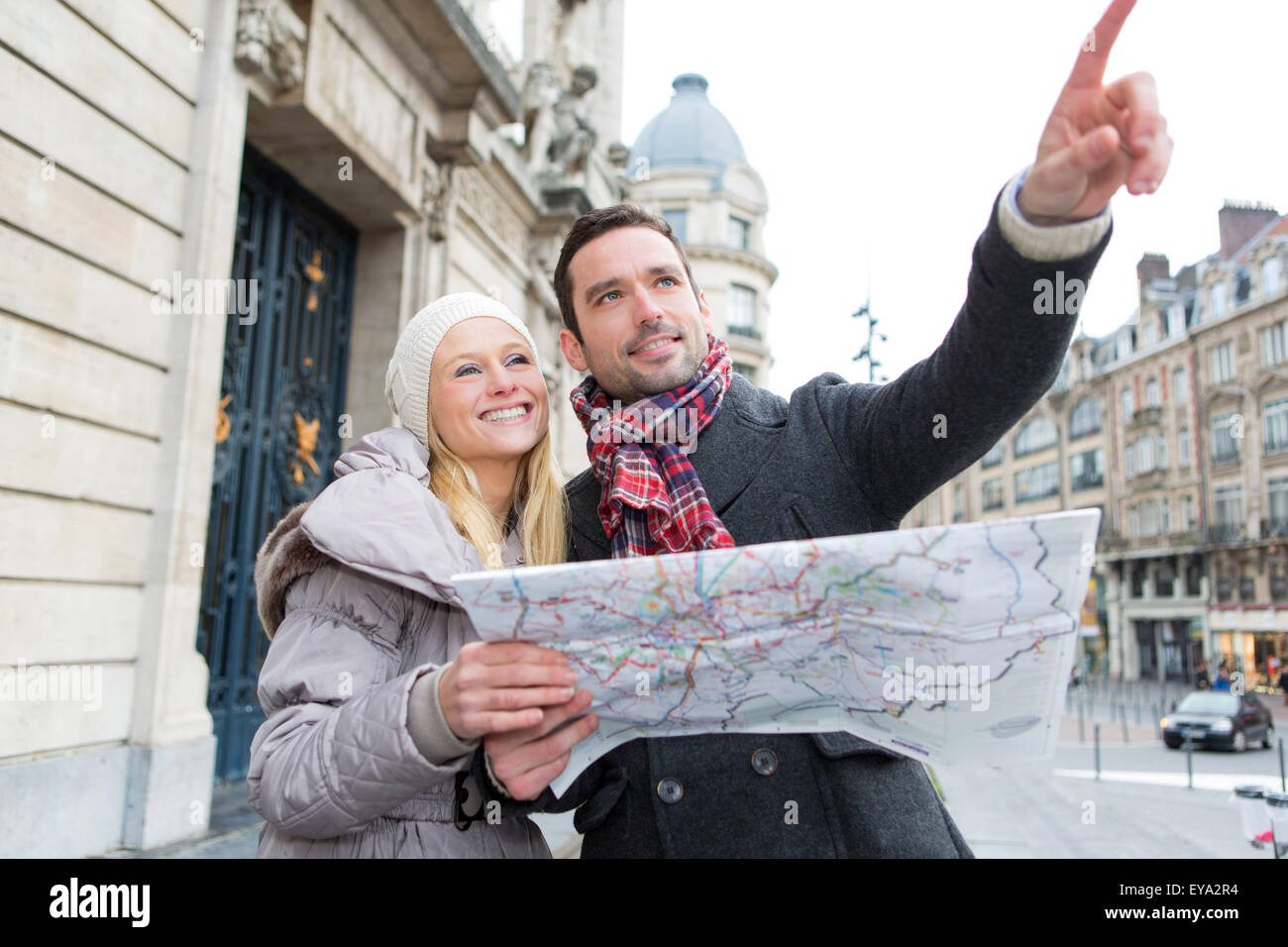 View of a young attractive tourist watching map Stock Photo - Alamy