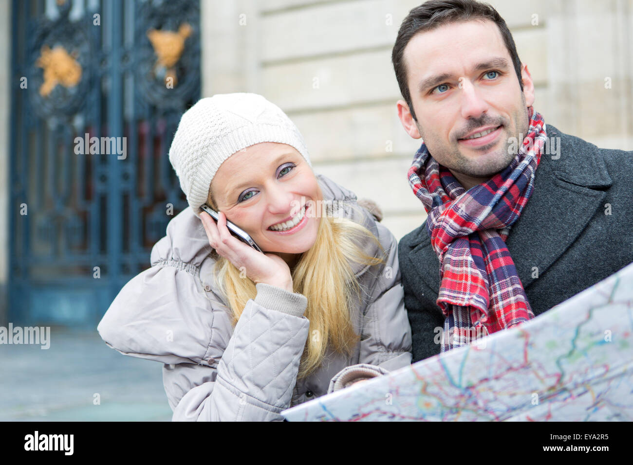 View of a young attractive tourist watching map Stock Photo - Alamy