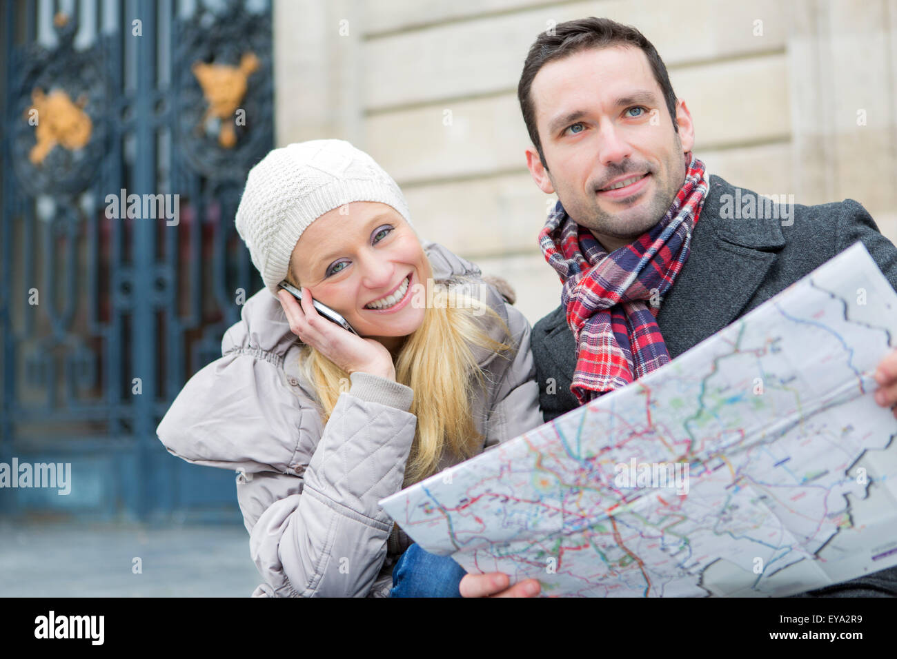 View of a young attractive tourist watching map Stock Photo - Alamy