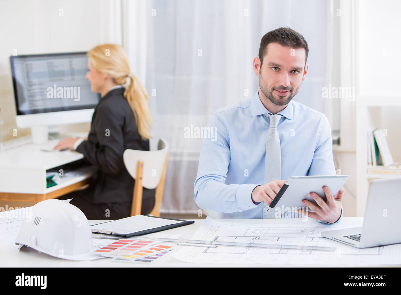 View of a Young attractive engineer working at the office Stock Photo ...