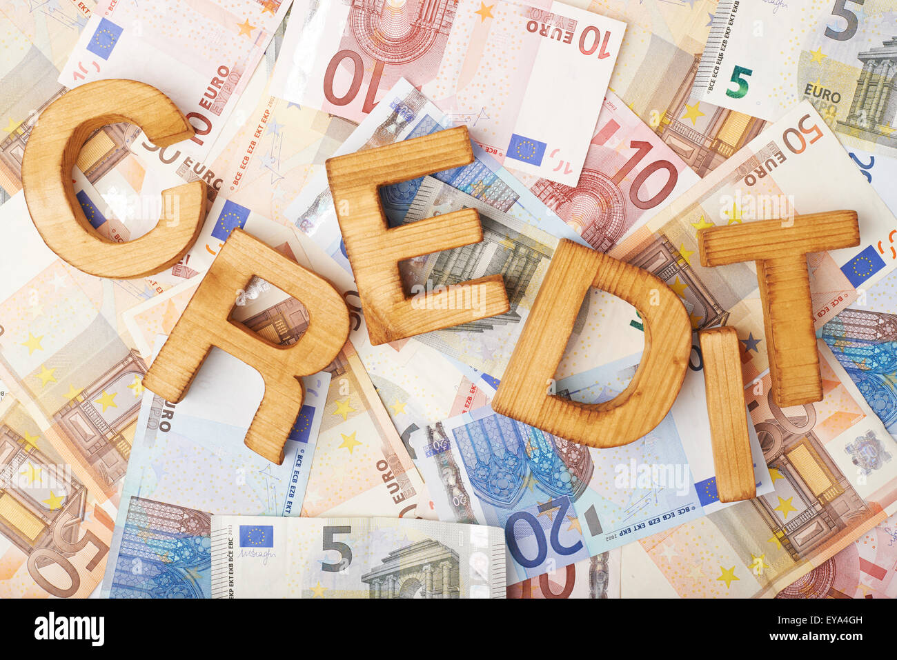 Word Credit over the pile of money Stock Photo - Alamy