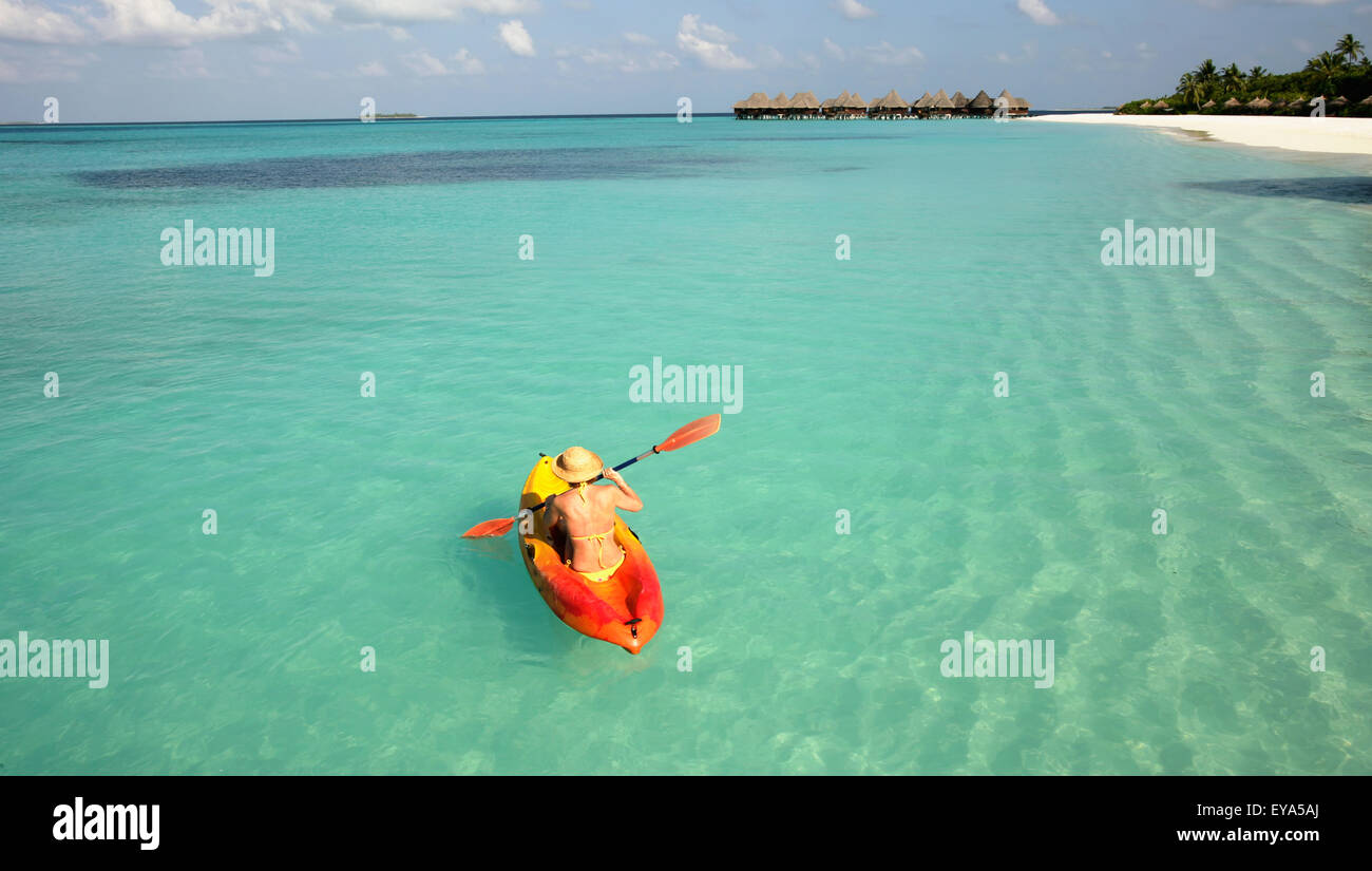 Woman Paddling Canoe On Ocean,Elevated View, Dhuni Kolhu Island ...