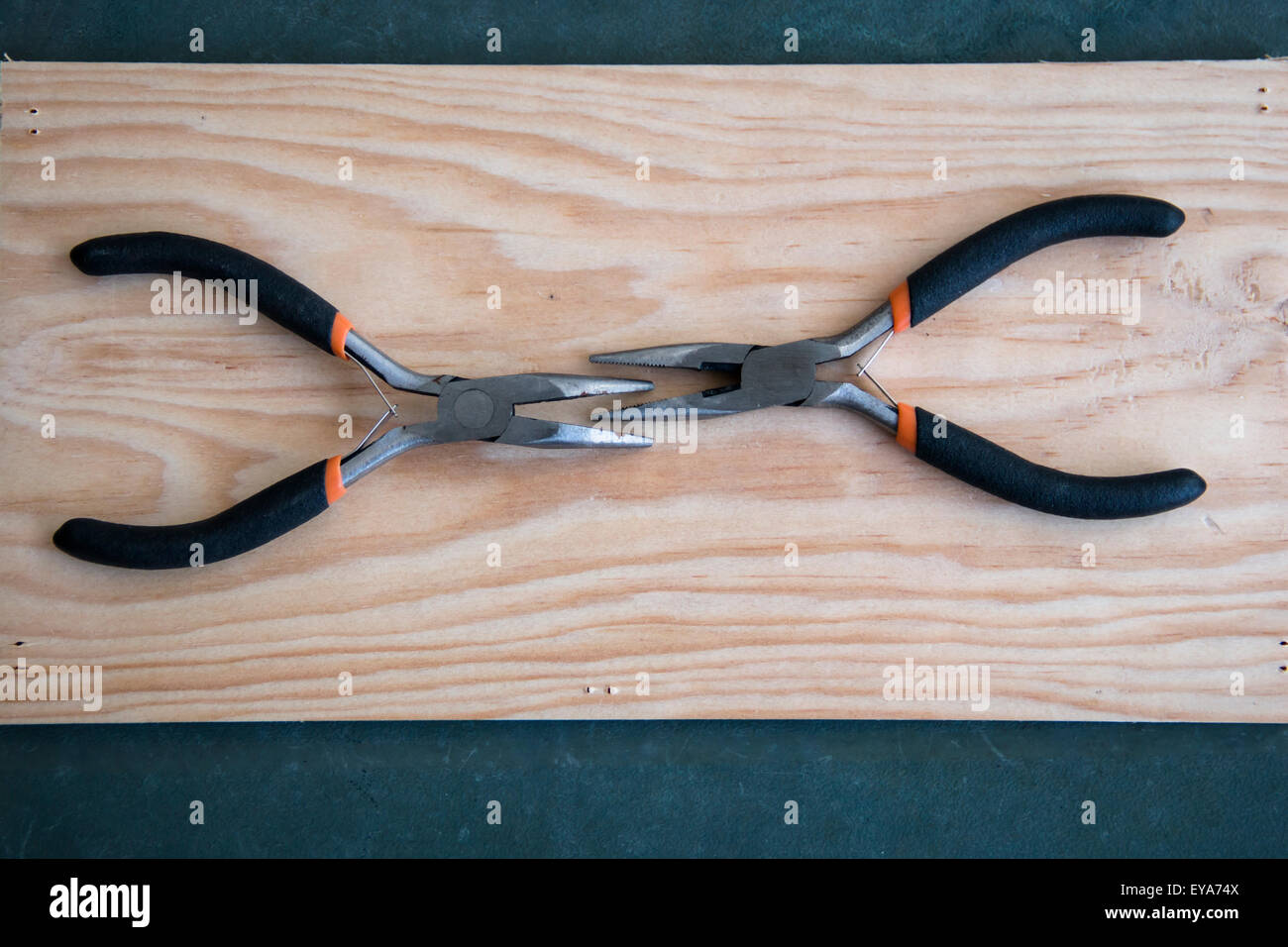 Set of two pincers on wood background Stock Photo - Alamy