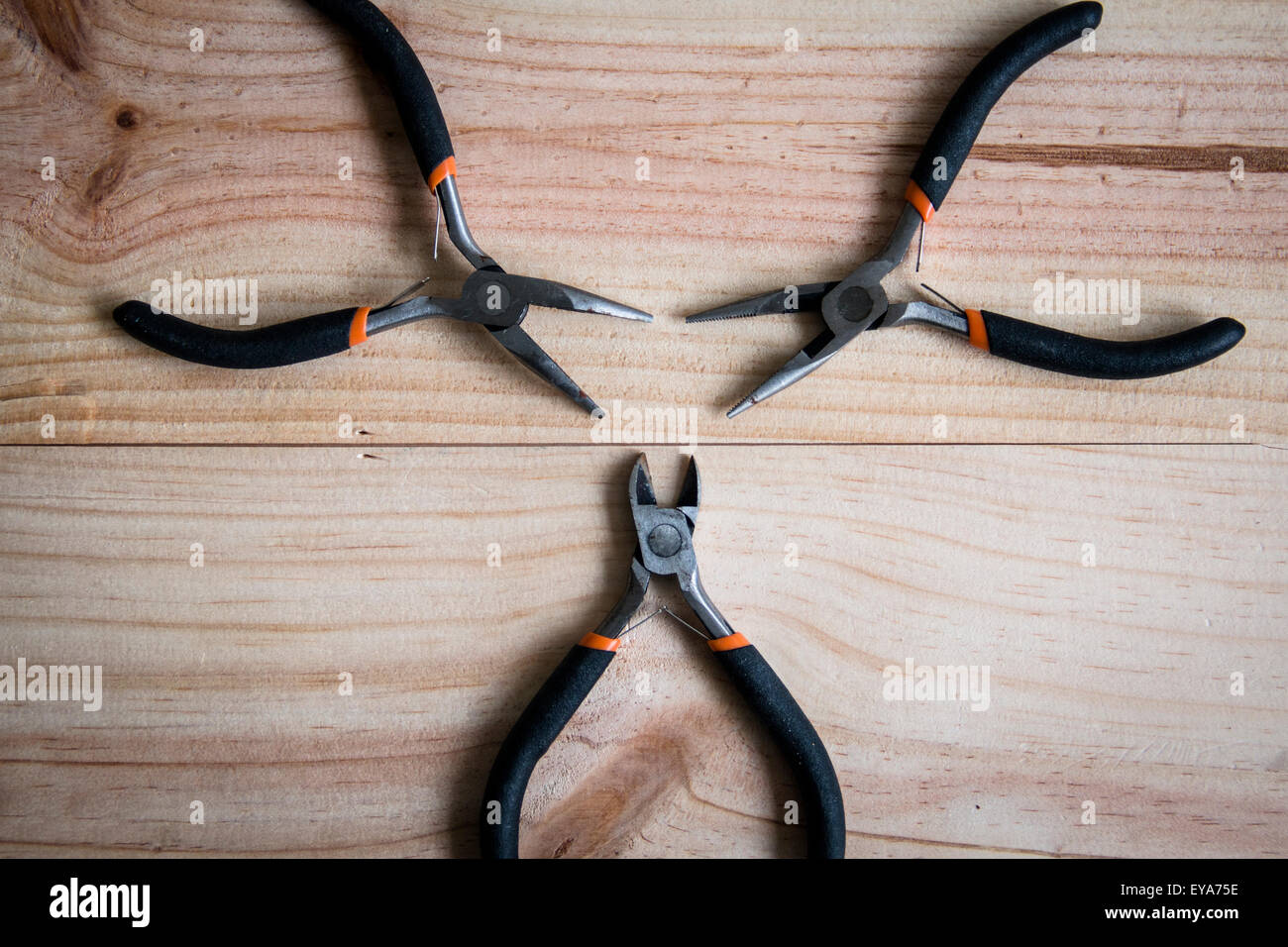 Set of three pincers on wood background Stock Photo - Alamy