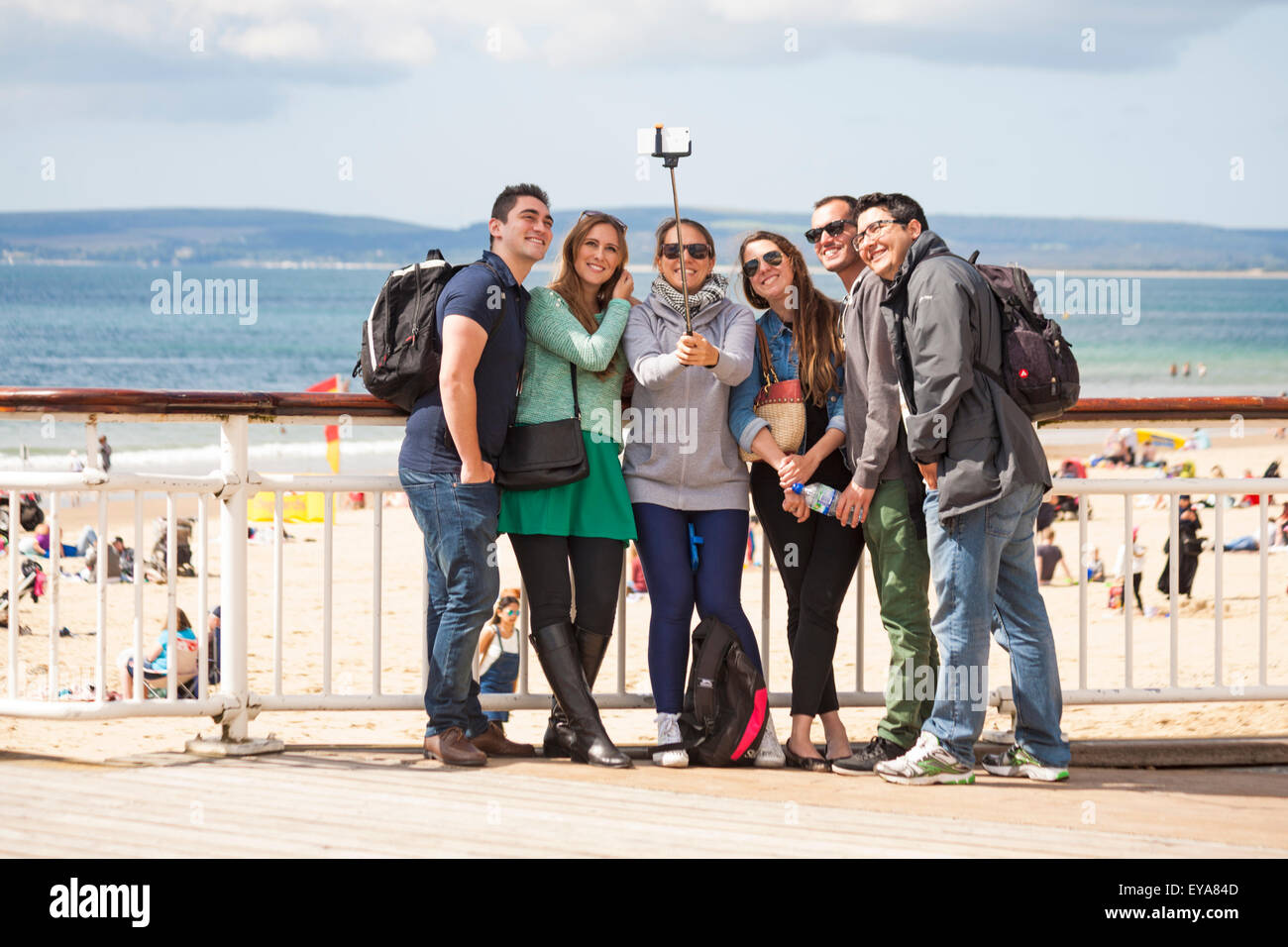 Bournemouth, Dorset, UK 25 July 2015. Group of young people standing on ...