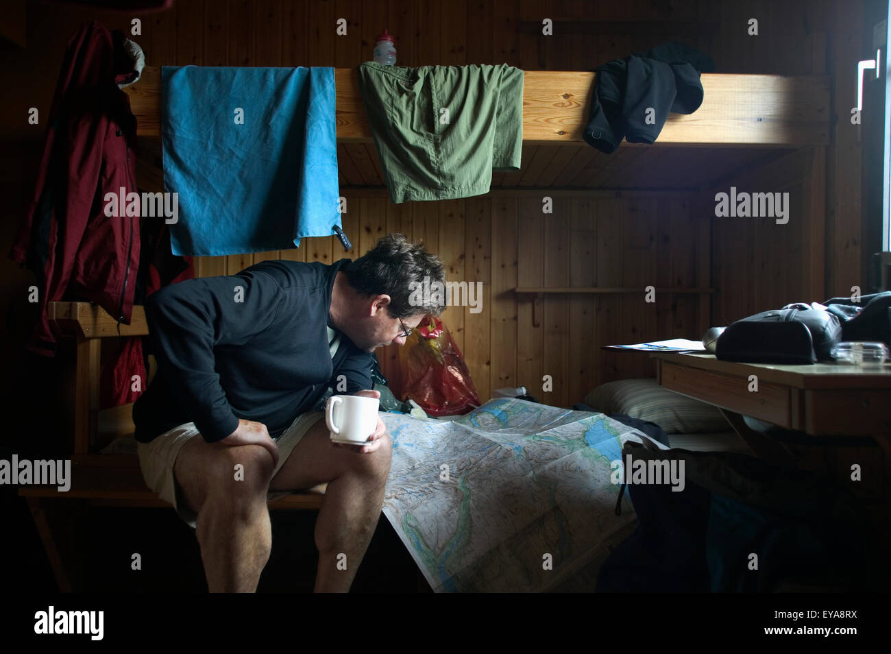 Man reading map inside hikers cabin hi-res stock photography and images ...