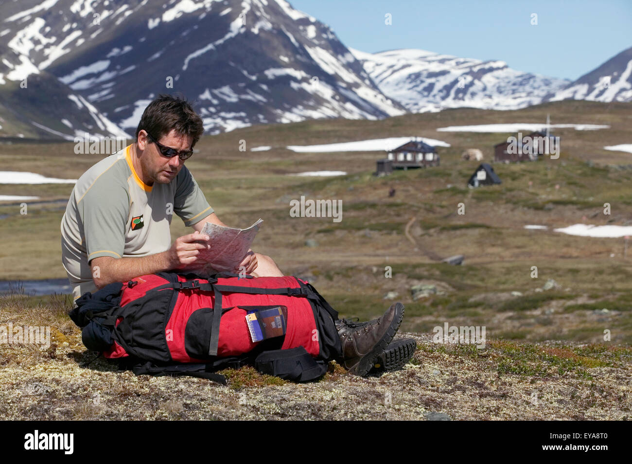Hiker checking map sitting in valley hi-res stock photography and ...