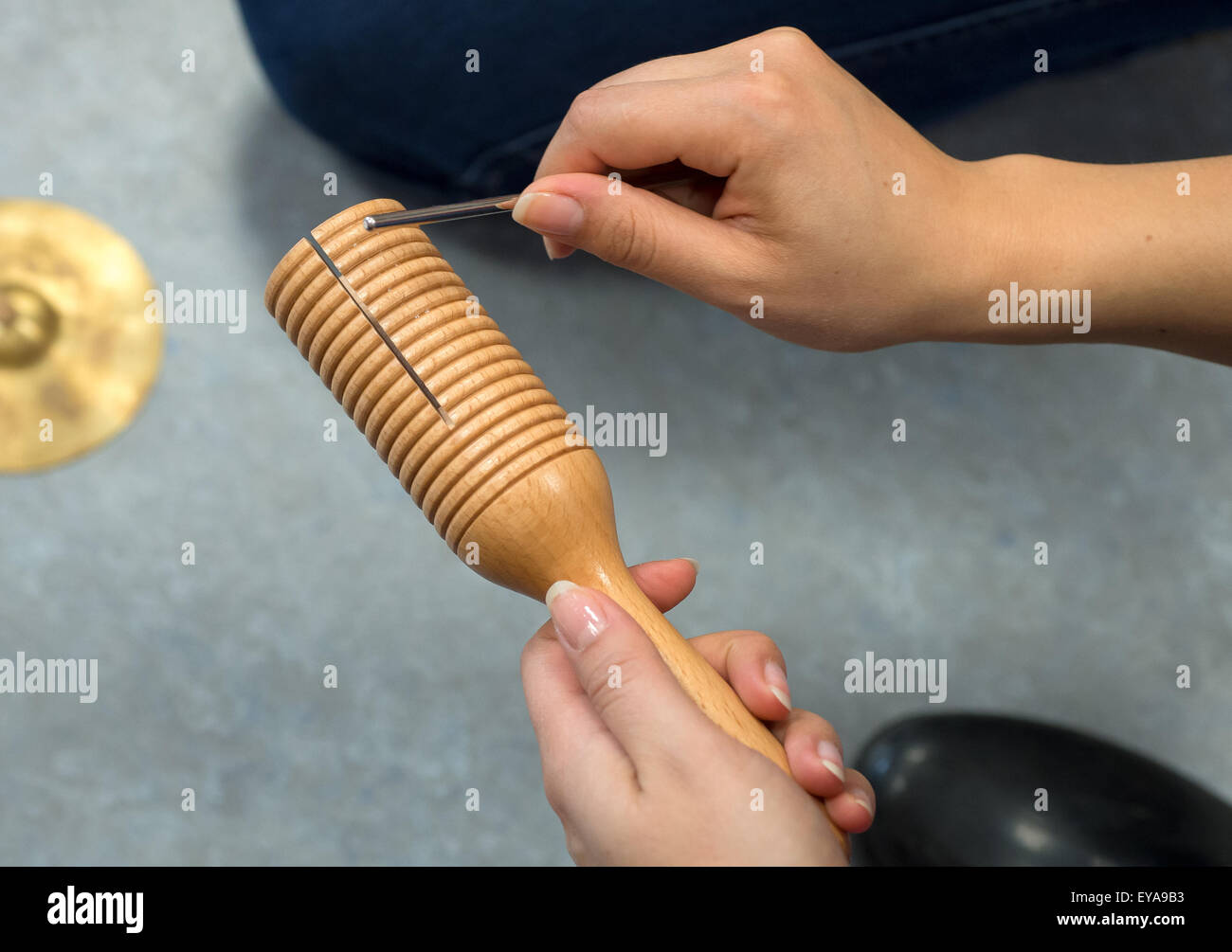Berlin, Germany, hands holding a rhythm instrument made of wood Stock ...