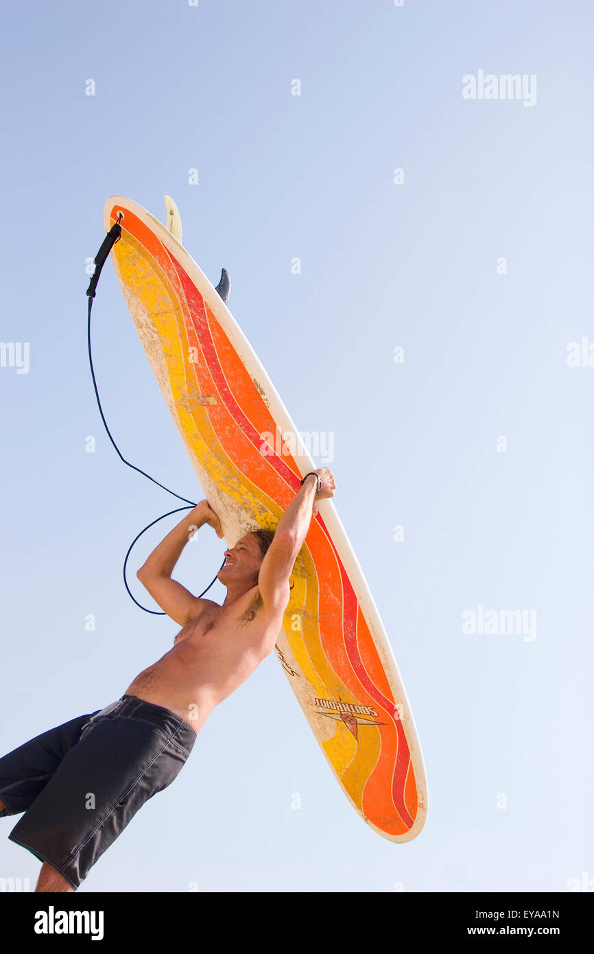 Man Carrying Surfboard,Low Angle View Against Blue Sky, Ditch Plains ...