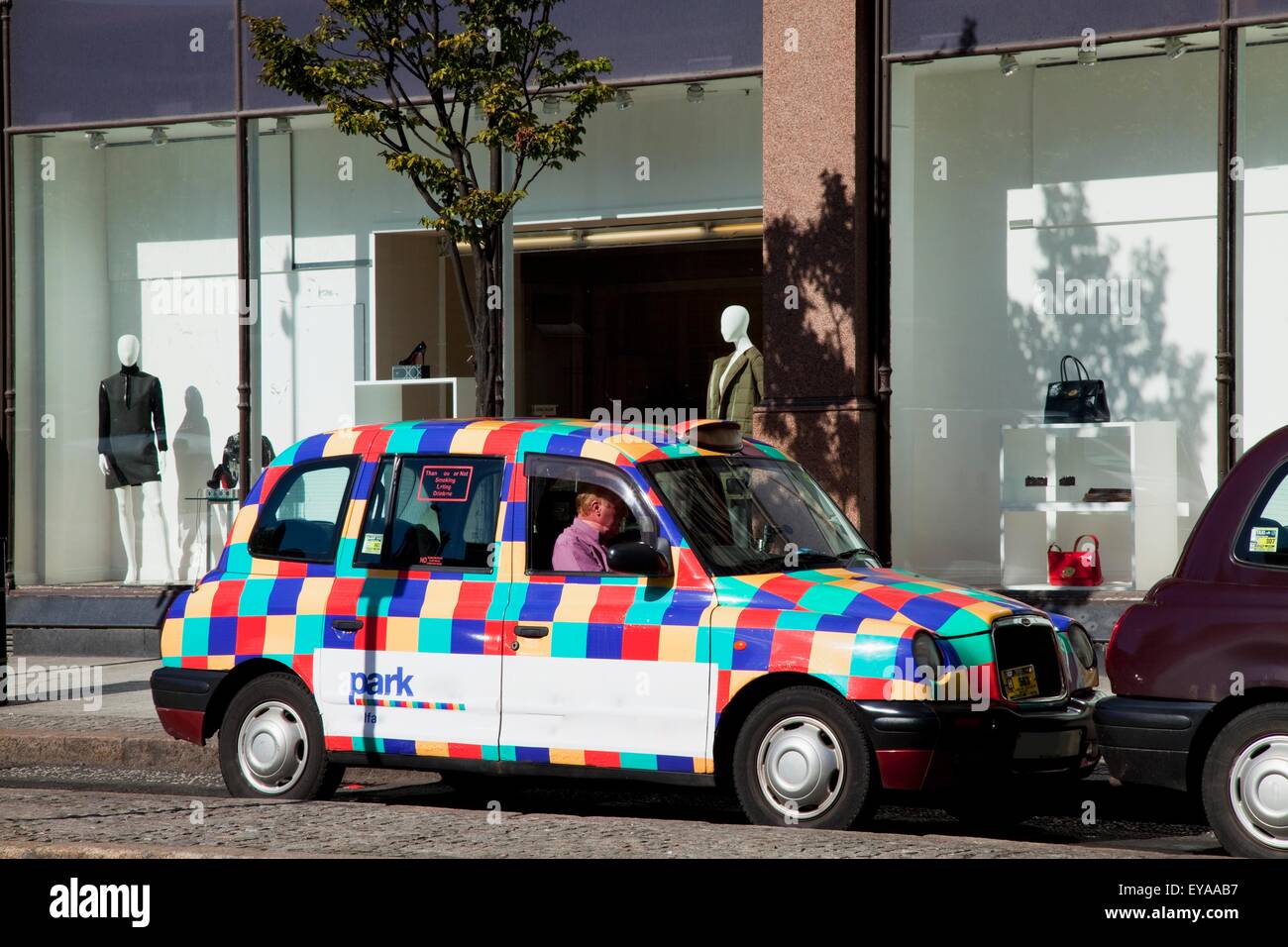A Taxi Parked On The Street; Belfast, Country Antrim, Ireland Stock ...