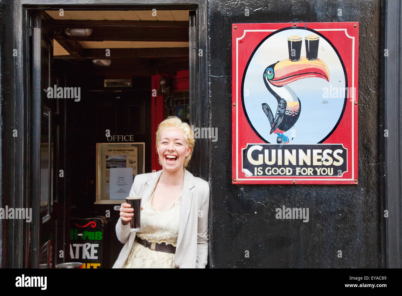 Woman With A Glass Of Guinness Ale Outside Pub; Killarney, County Kerry ...