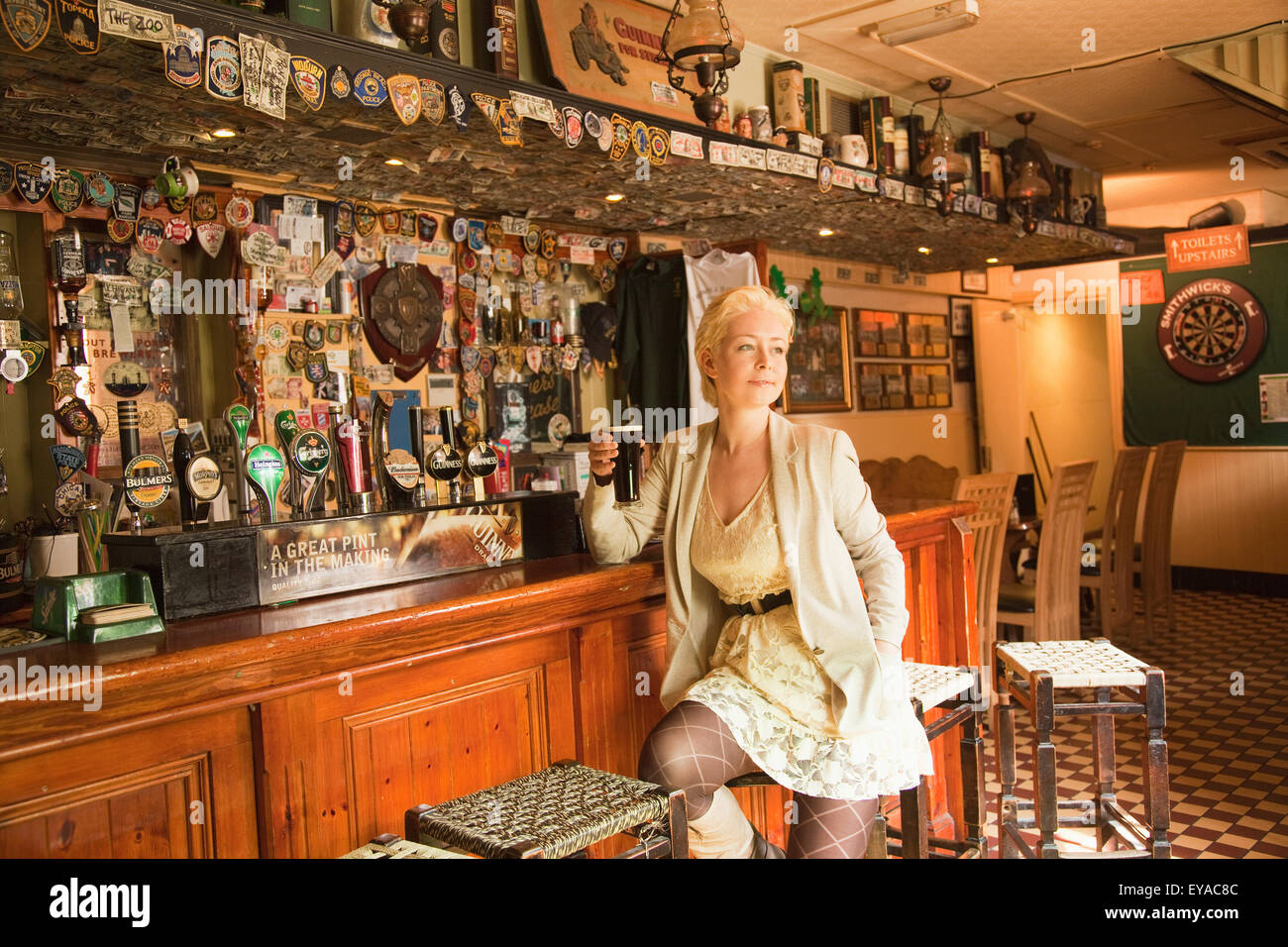 Woman Drinking Guinness Ale Inside Pub; Killarney, County Kerry ...