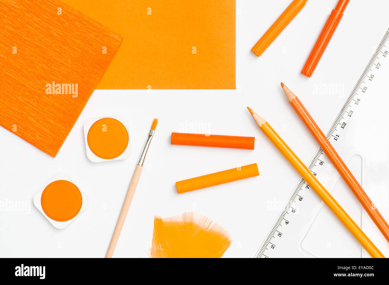 orange color school supplies on white paper background Stock Photo - Alamy