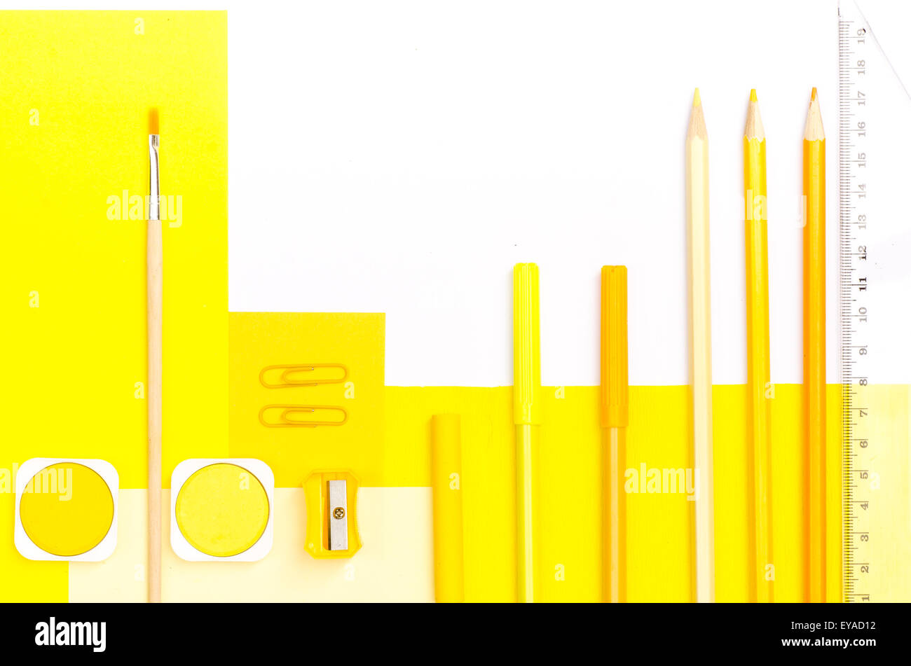 yellow color school supplies on white paper background Stock Photo - Alamy