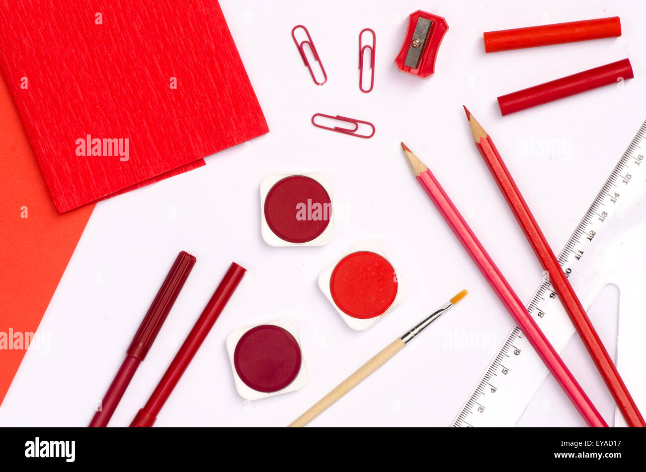 red color school supplies on white paper background Stock Photo - Alamy