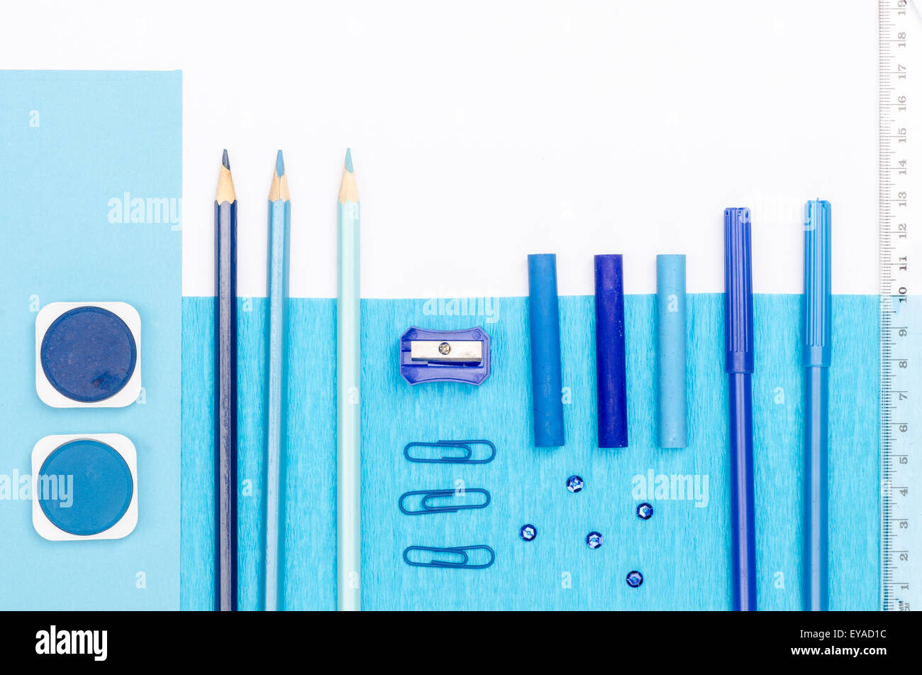 blue color school supplies on white paper background Stock Photo - Alamy