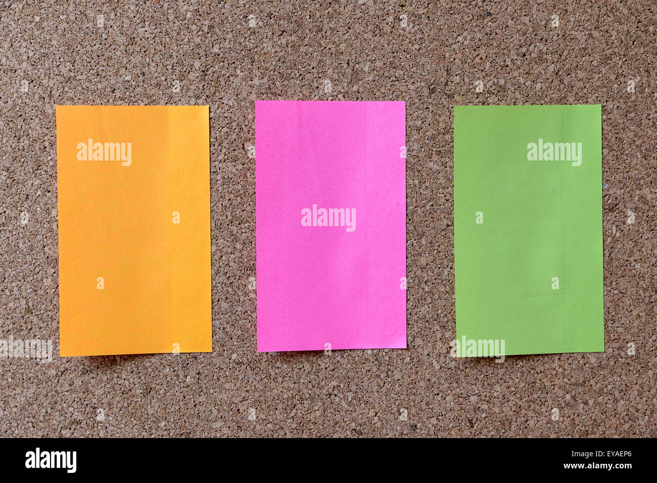 three color note on corkboard Stock Photo - Alamy