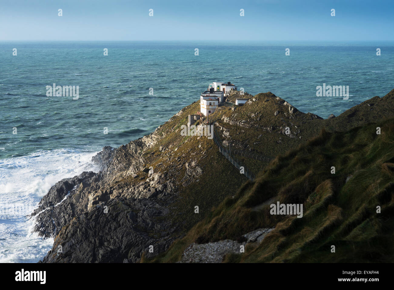 A building on the edge of the cliff overlooking the ocean; County Cork ...