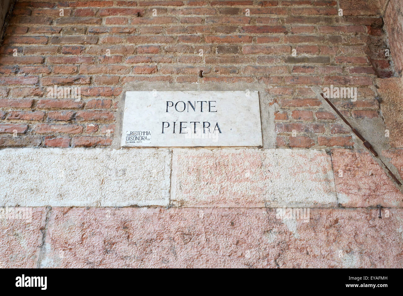 VERONA, ITALY - JULY 13: Street sign for Ponte Pietra on old brick wall ...