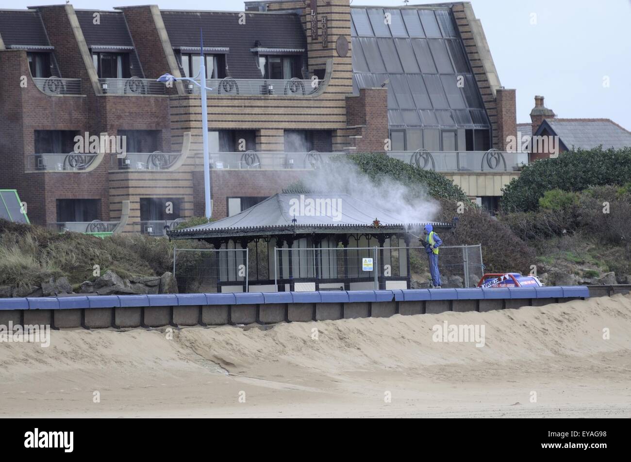 Man using high pressure water spray to clean shelter Stock Photo - Alamy