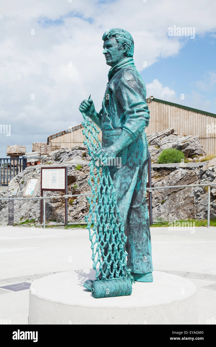 Statue of fisherman with net at the waterfront; Fenit, County Kerry ...