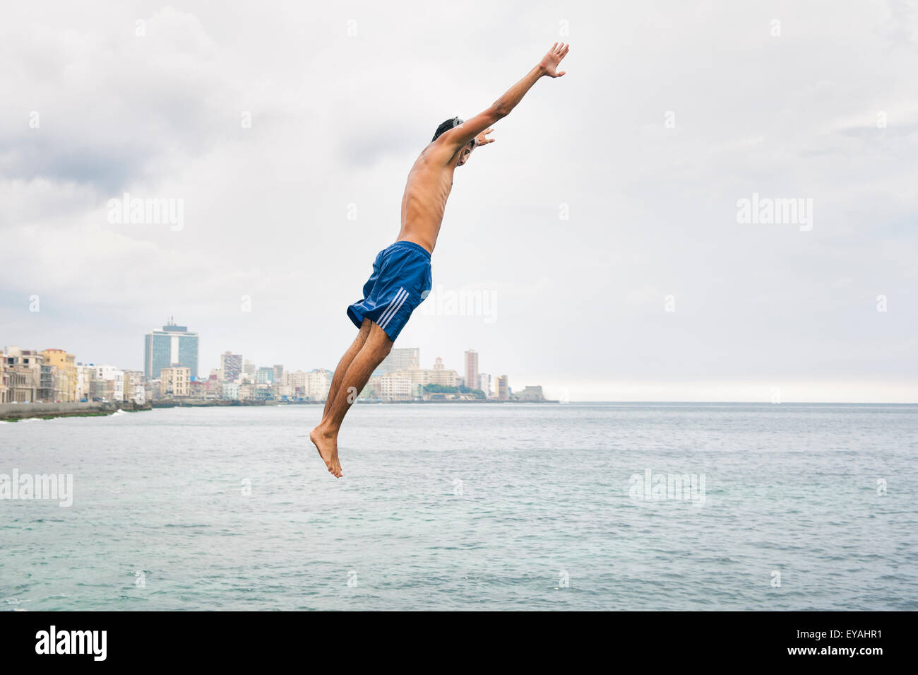 HAVANA, CUBA - MAY 23, 2011: A young Cuban dives into the water from ...