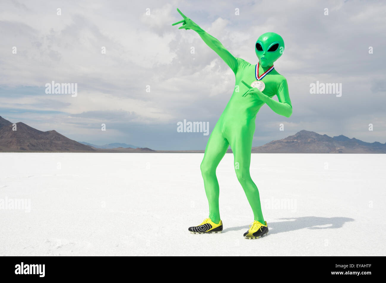 Green alien track star athlete wearing gold medal celebrating with ...