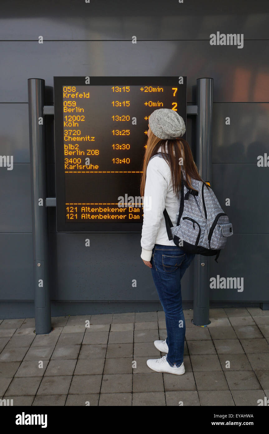passenger looking at destination board Stock Photo - Alamy