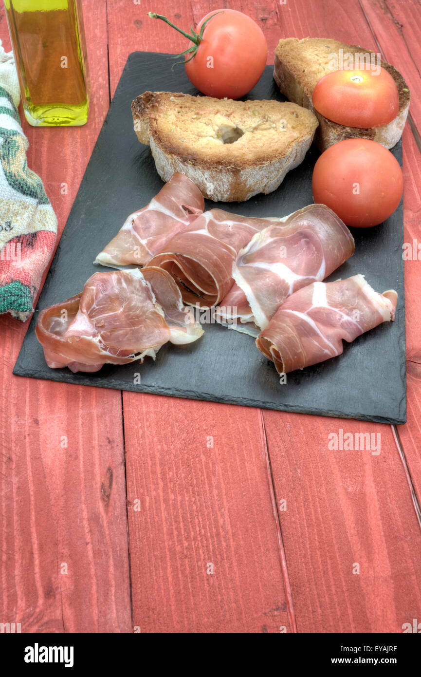 a vertical view of a traditional mediterranean dish, pan tumaca with ...
