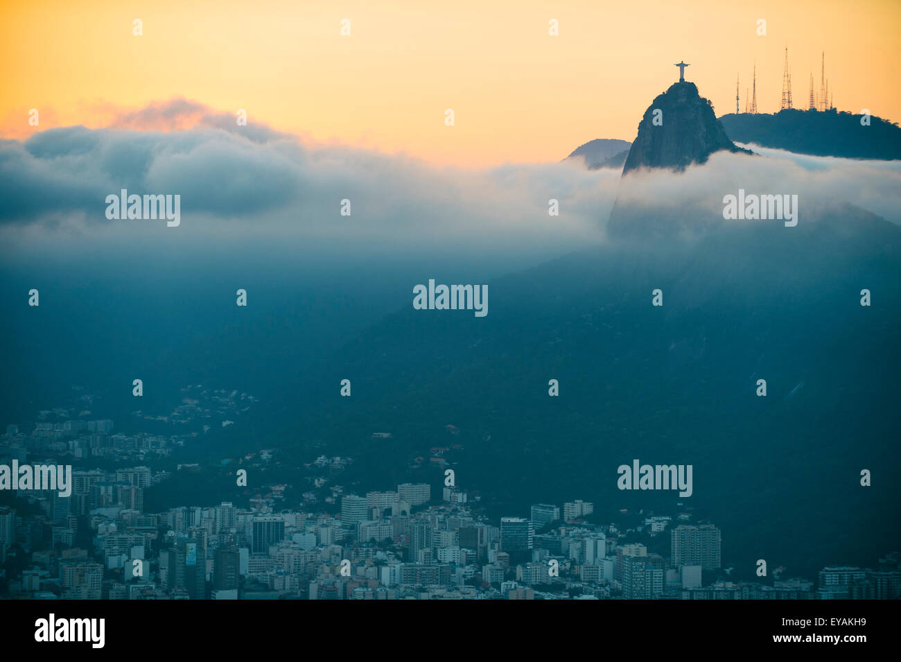 Corcovado mountain Christ the Redeemer standing in golden sunset above ...