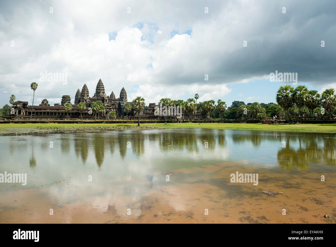 Ancient temple complex of Angkor Wat reflecting in still water under ...