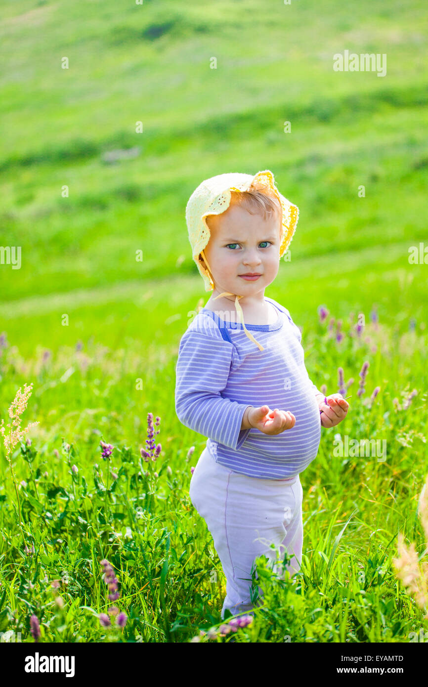 Portrait of 1 year old baby girl enjoying a day on a meadow Stock Photo ...