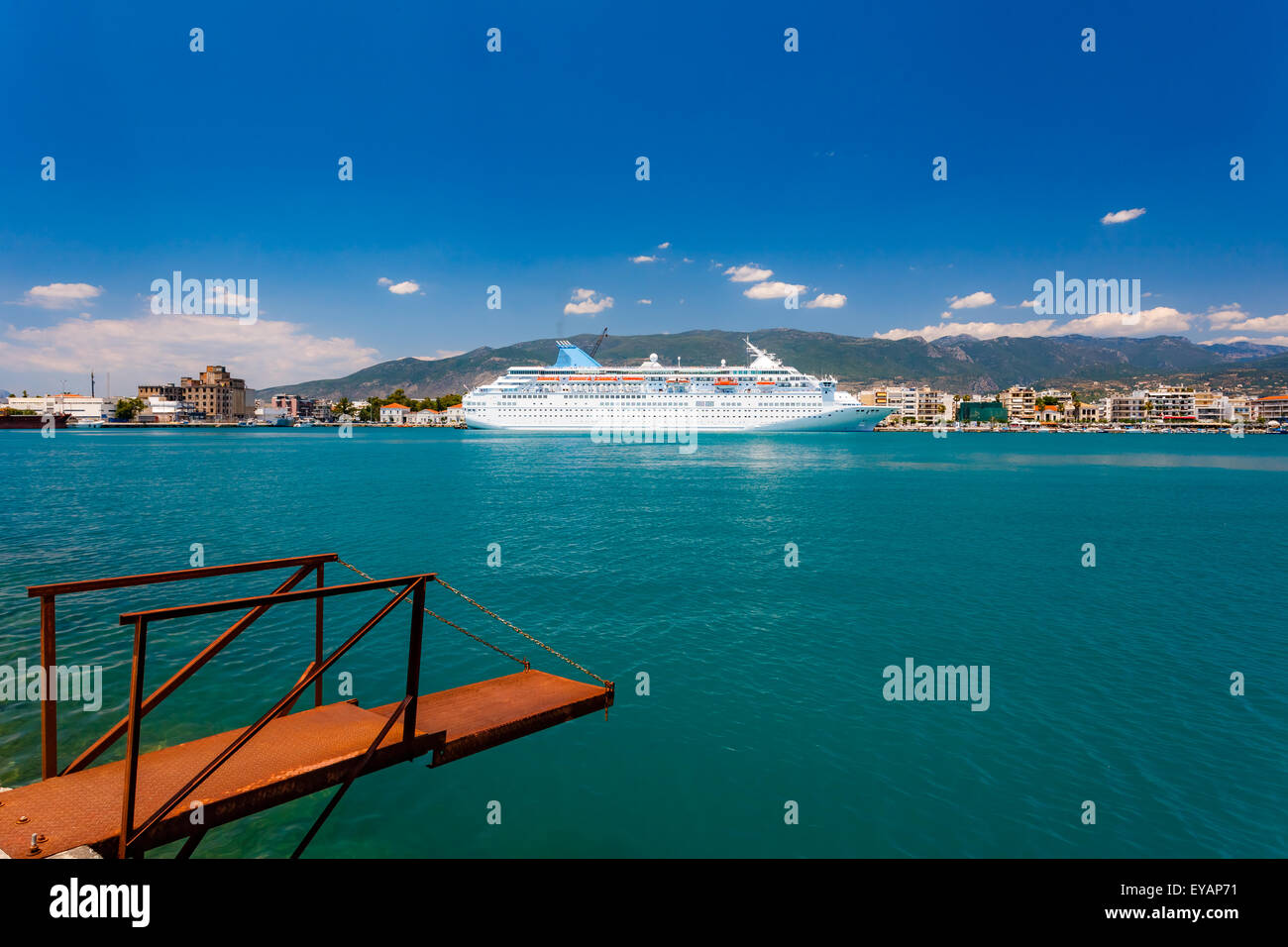 Big cruise ship anchored in port against a blue sky and clouds with ...