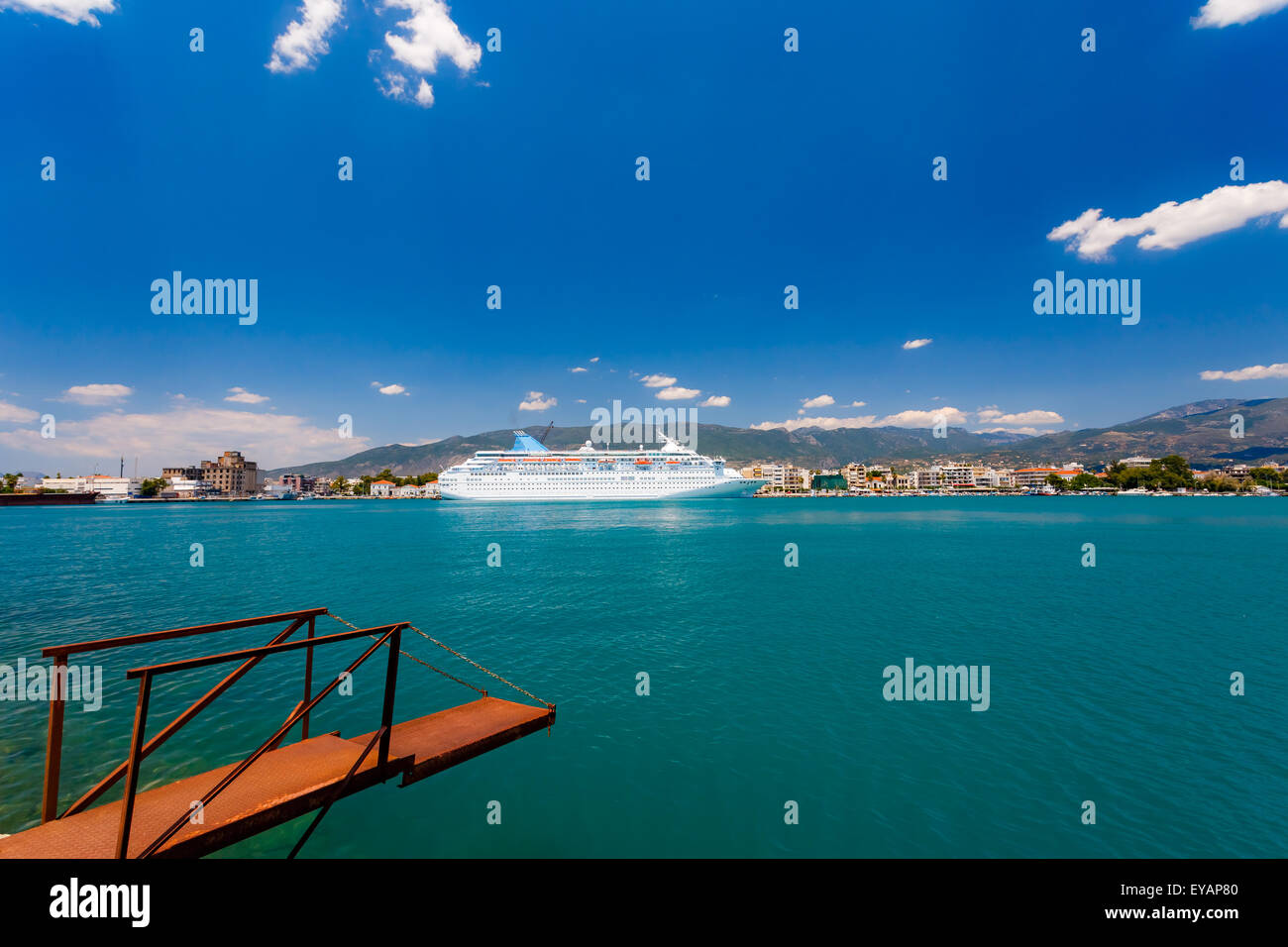 Big cruise ship anchored in port against a blue sky and clouds with ...