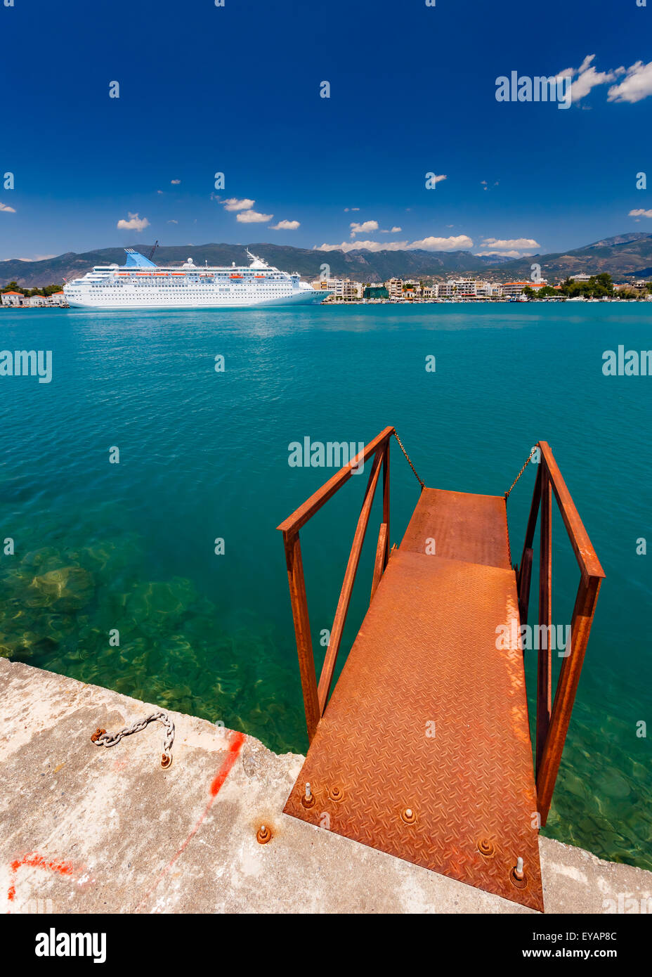 Big cruise ship anchored in port against a blue sky and clouds with ...