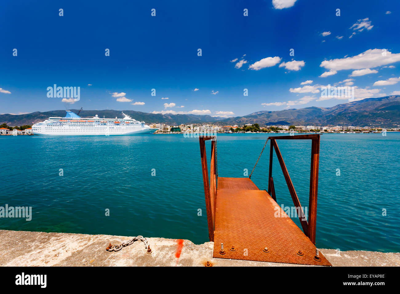 Big cruise ship anchored in port against a blue sky and clouds with ...