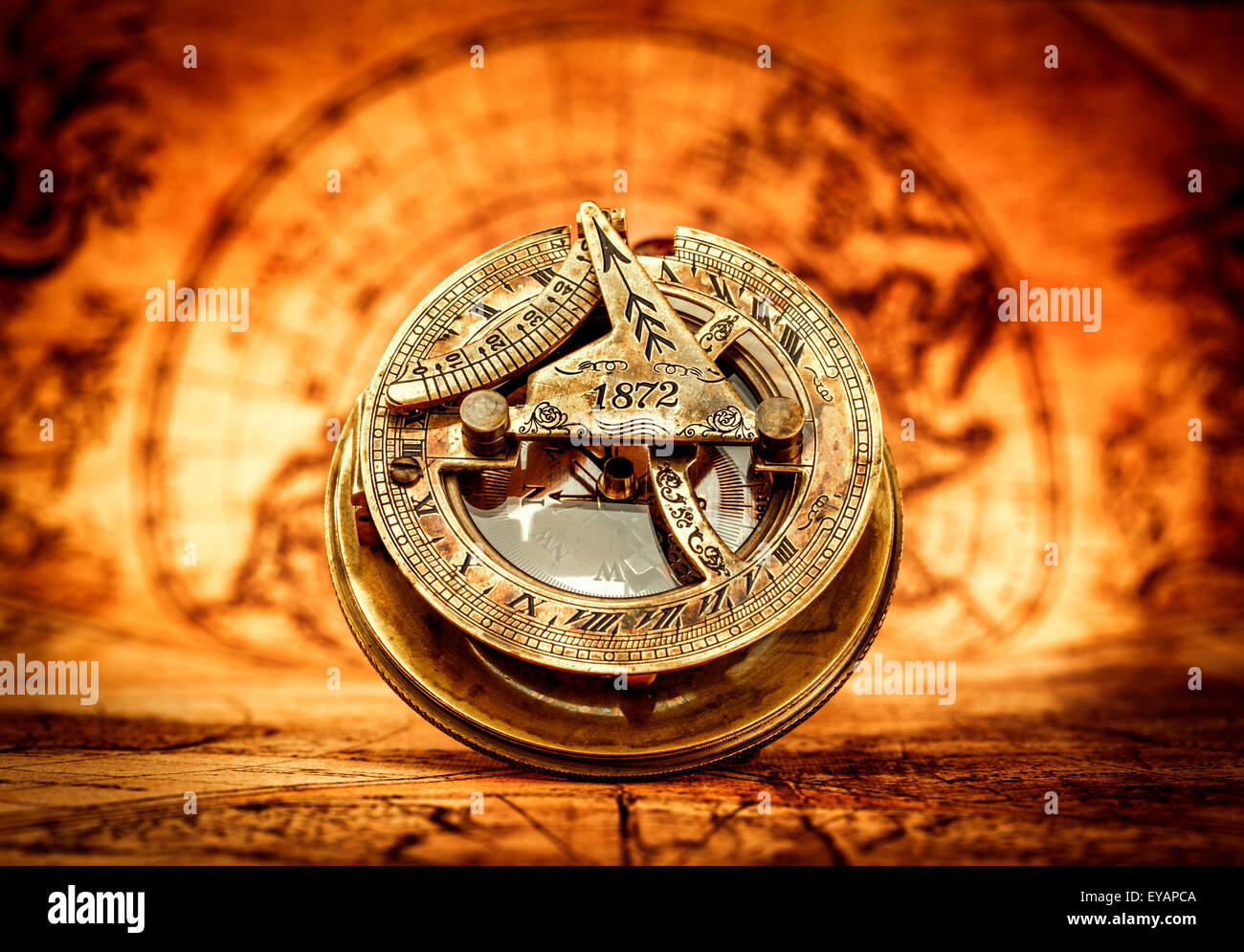 Vintage still life. Vintage compass lies on an ancient world map in ...
