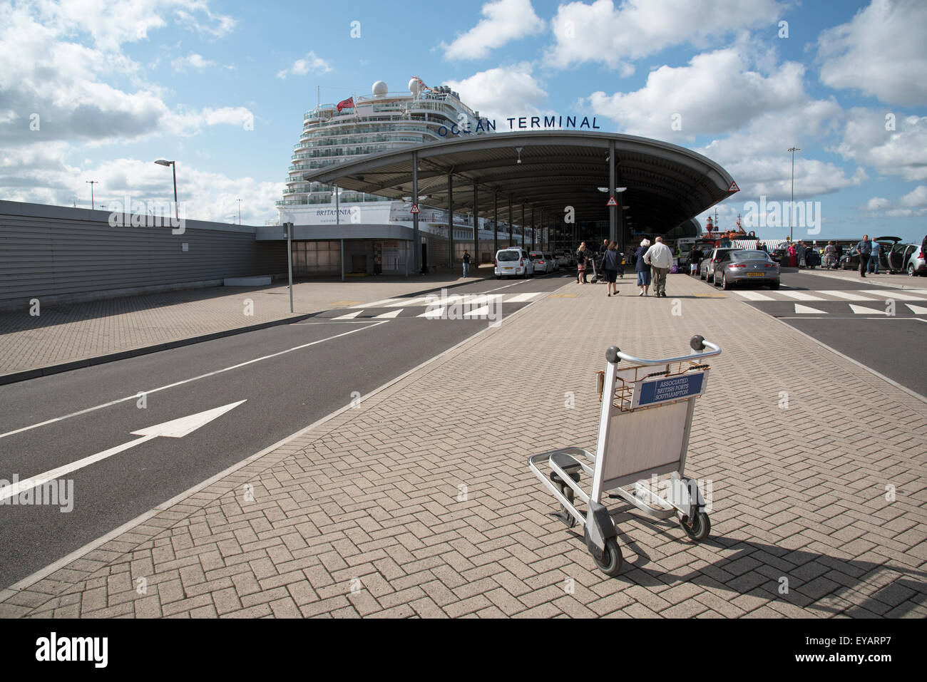 Cruise ship alongside Ocean terminal a baggage trolley on walkway at ...