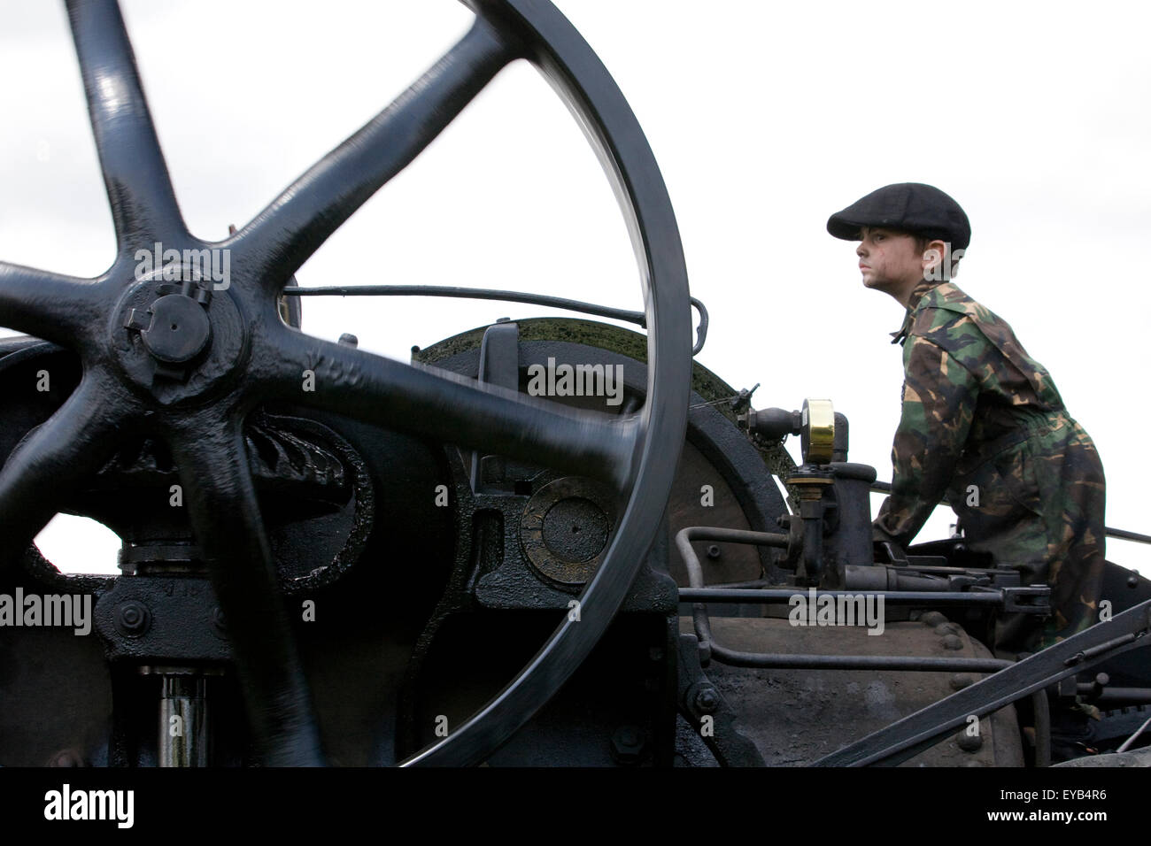 Coal boy working a steam engine Stock Photo - Alamy