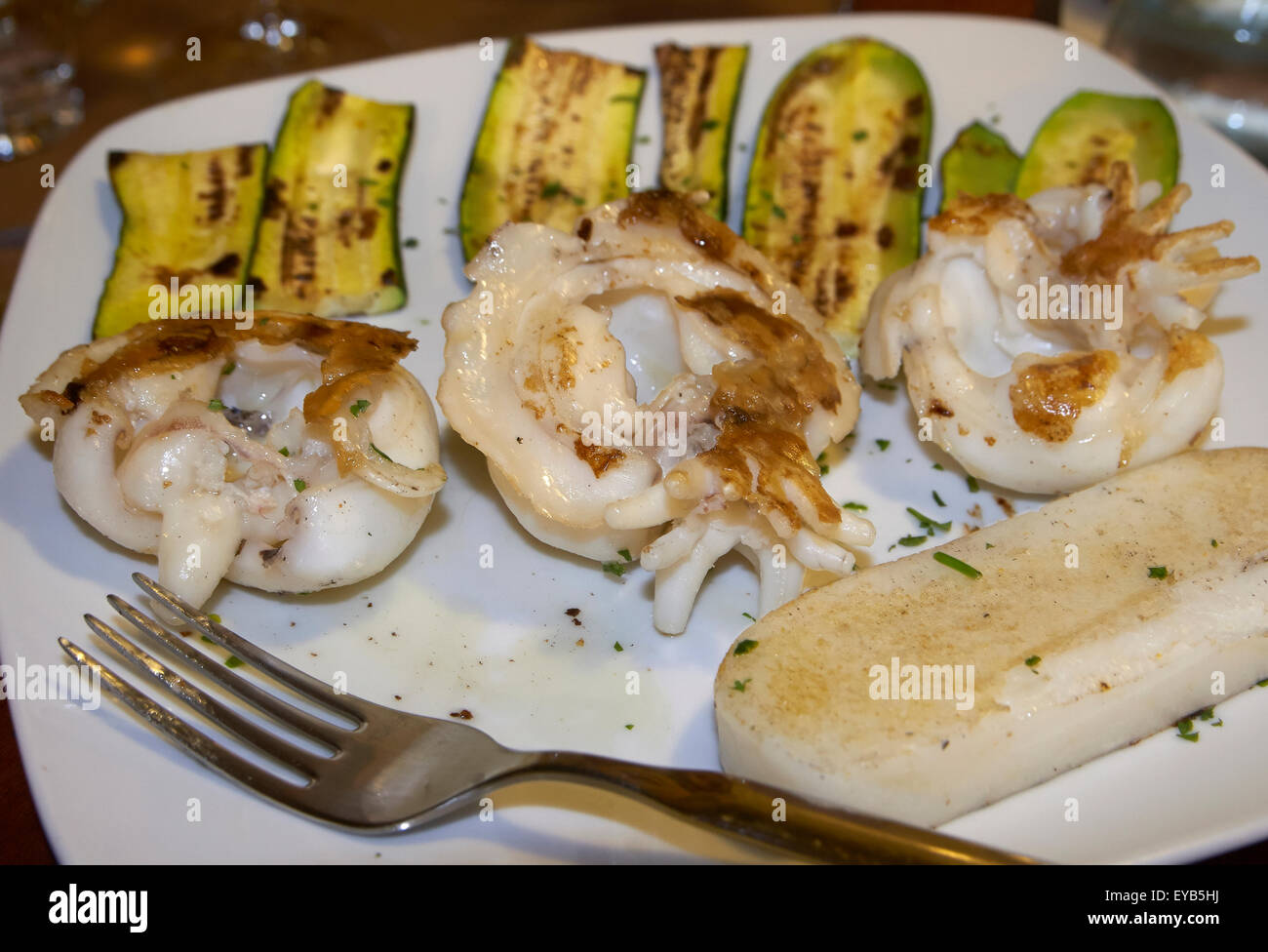 skewers of grilled cuttlefish with zucchini and white polenta, italian ...