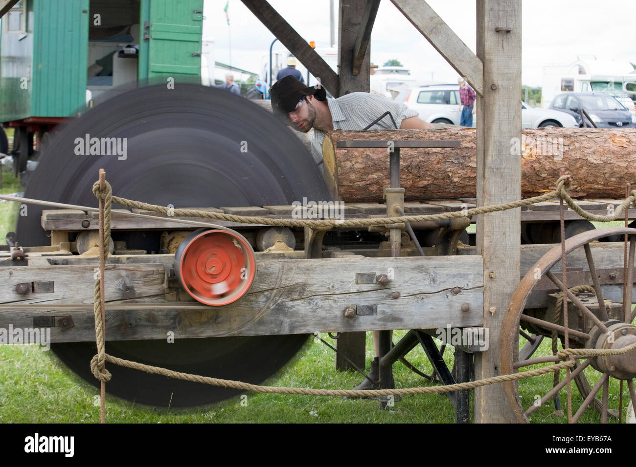 man working a traditional wood Saw mill Blade operated by a traction ...