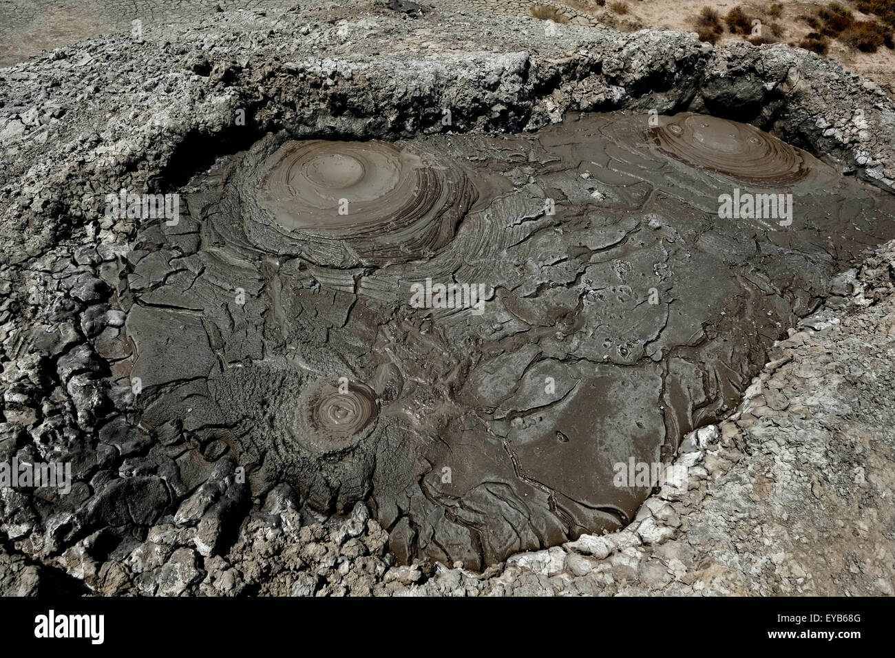 Mud bubbles and erupts from a mud volcano following a build-up of ...