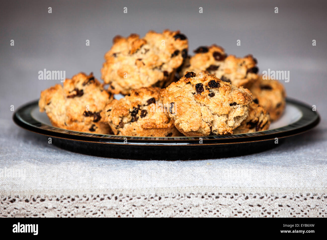 A plate of freshly baked Rock Cakes on a plate placed on a table with a ...