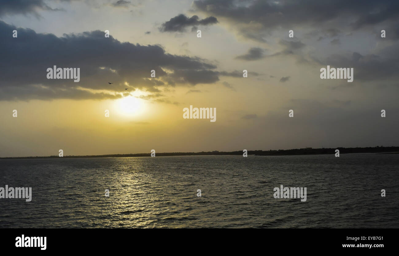 Sun setting on an autumn evening over the sea with hi-res stock ...