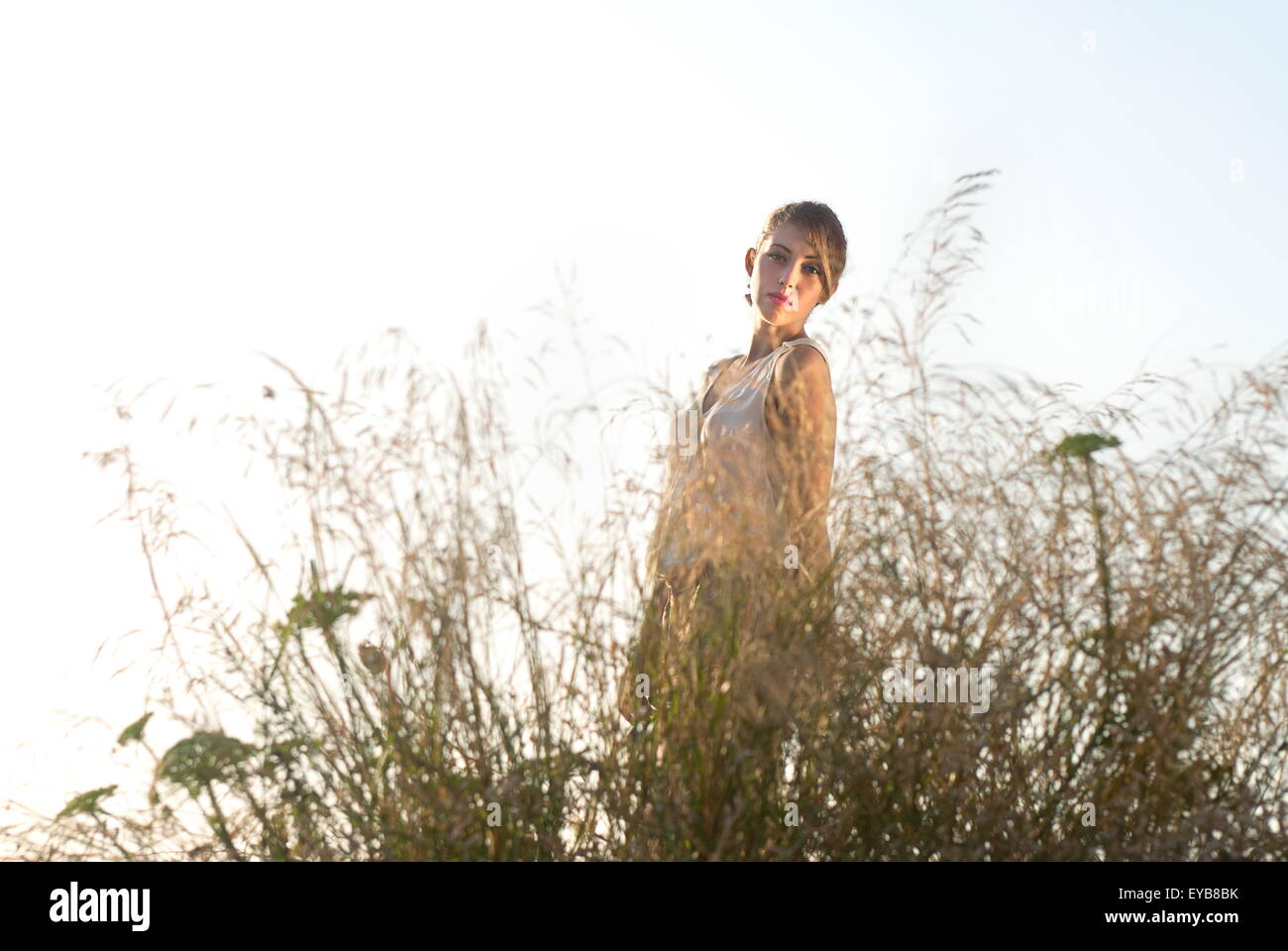 Young standing behind a bush hi-res stock photography and images - Alamy
