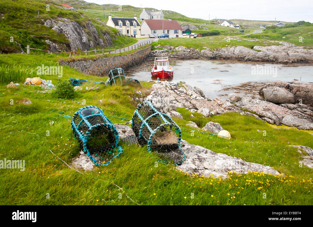 Small fishing boat and lobster pots on the east coast of Barra, Outer ...